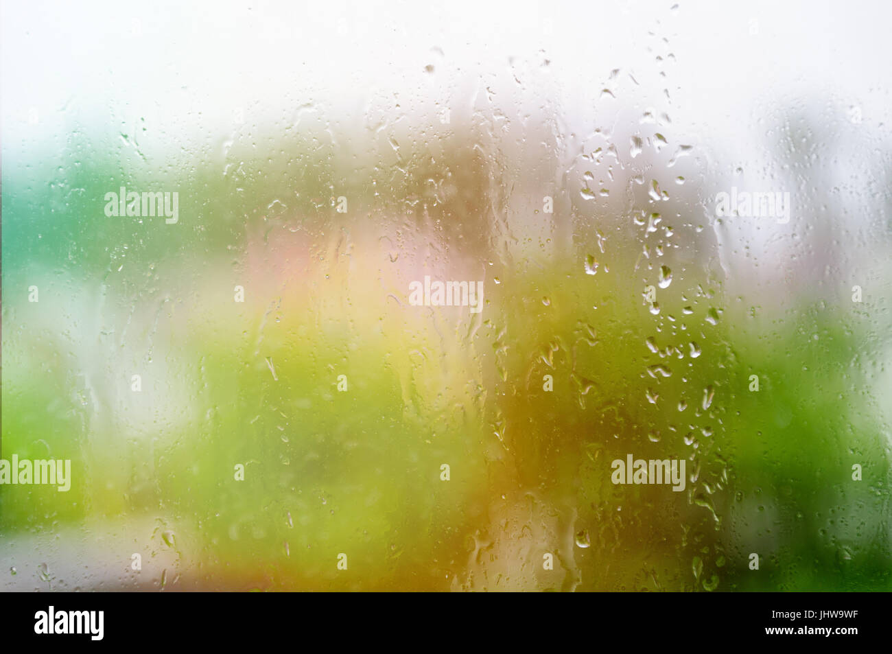 Wet window with drops, countryside, blur background Stock Photo - Alamy