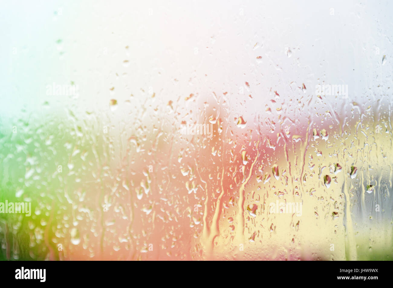 Wet window with drops, countryside, blur background Stock Photo - Alamy