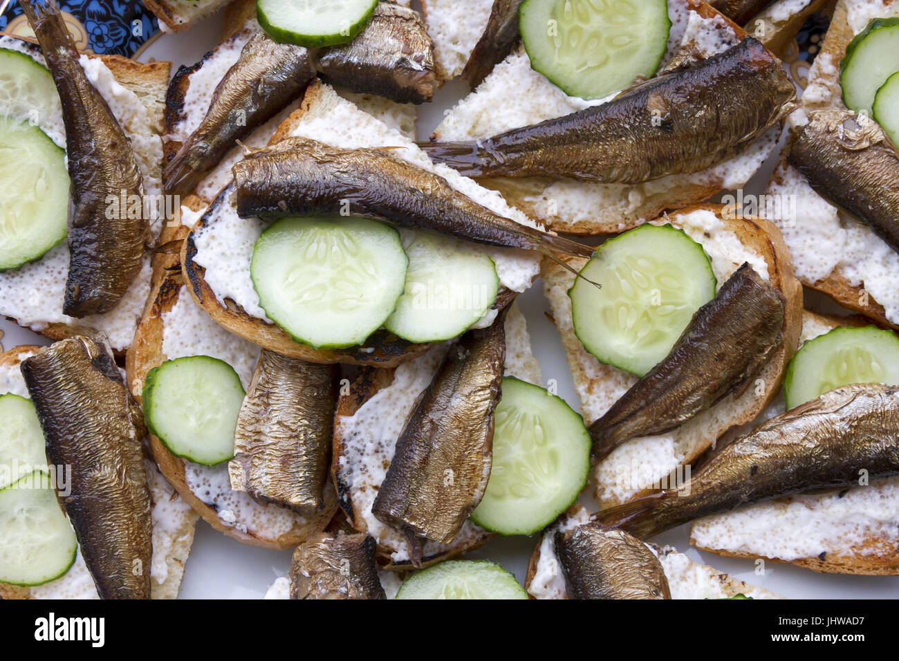 A large plate of sandwiches with sprats Stock Photo - Alamy