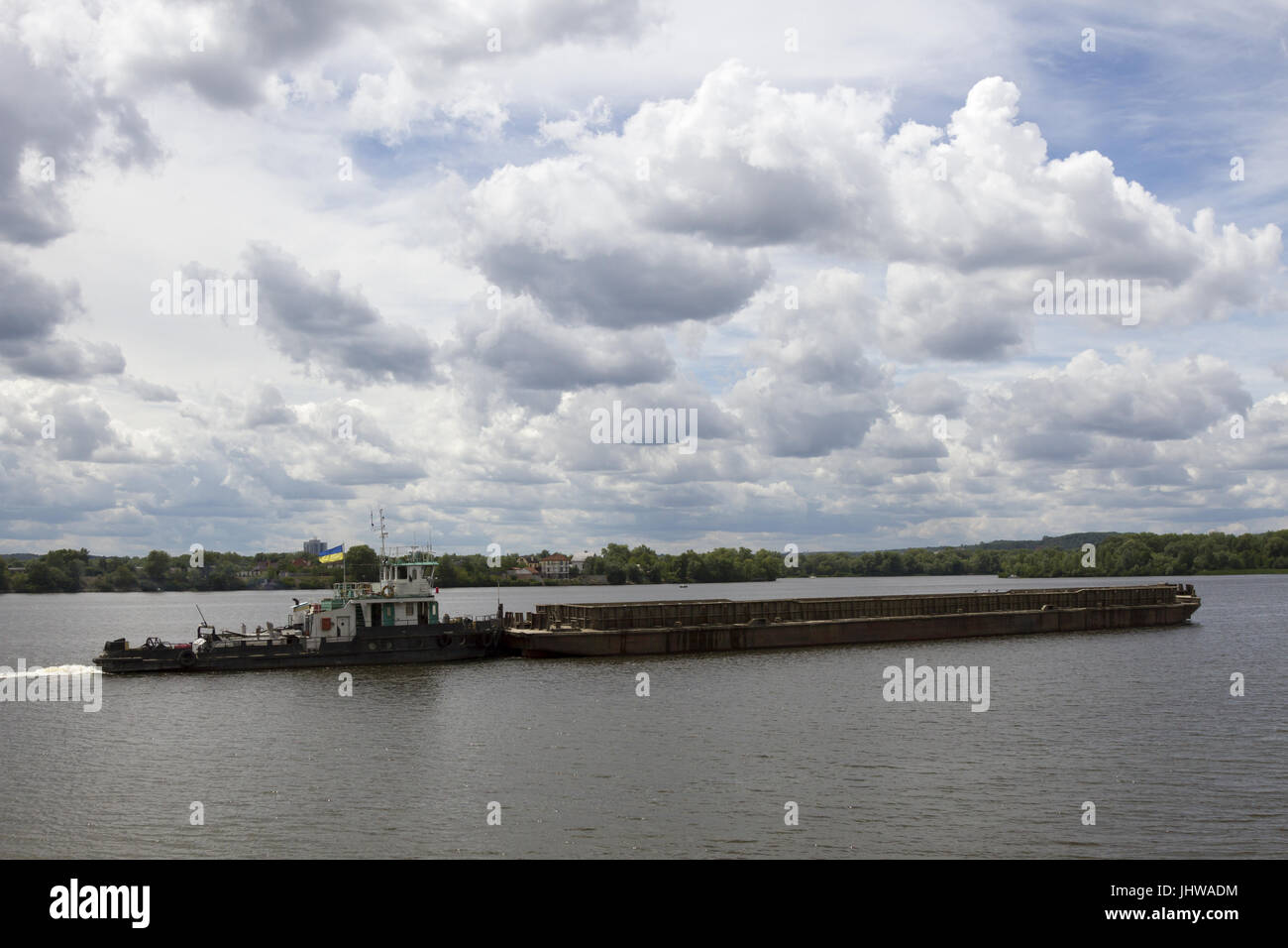 The old barge is floating along a wide river Stock Photo - Alamy