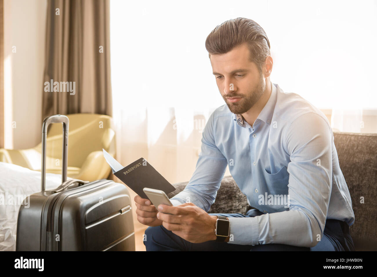 Young man business traveler hotel room accomodation Stock Photo - Alamy