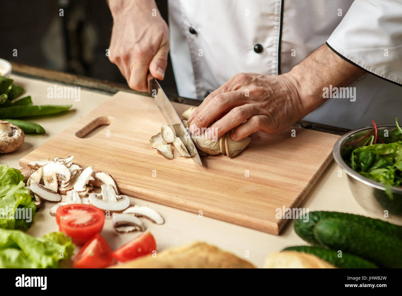 Mature man professional chef cooking meal indoors Stock Photo - Alamy