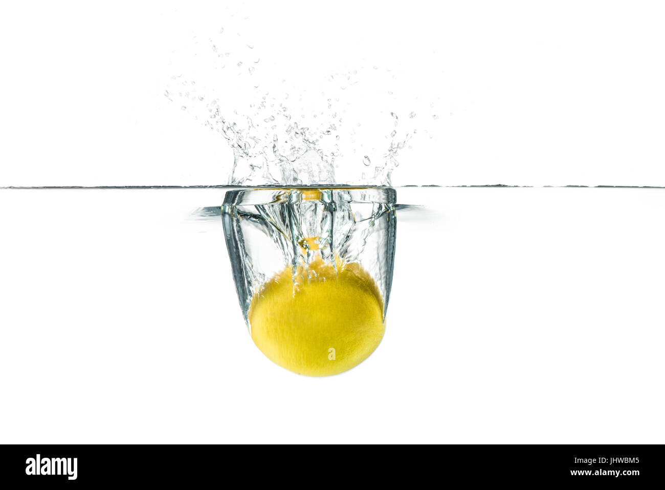 Fresh lemon dropped into the water with water splash on a white background Stock Photo - Alamy