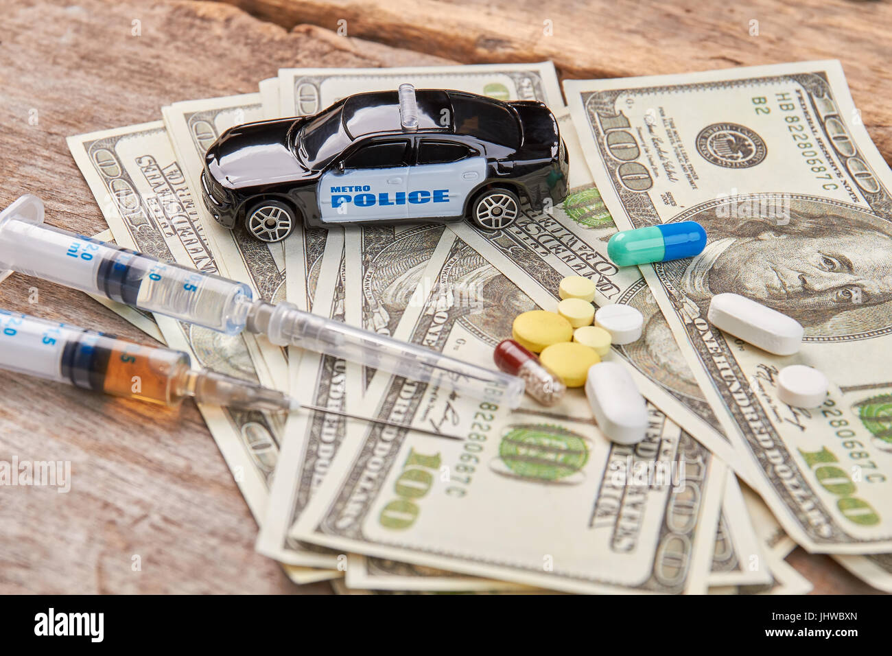 Police car, money, syringes, pills Stock Photo - Alamy