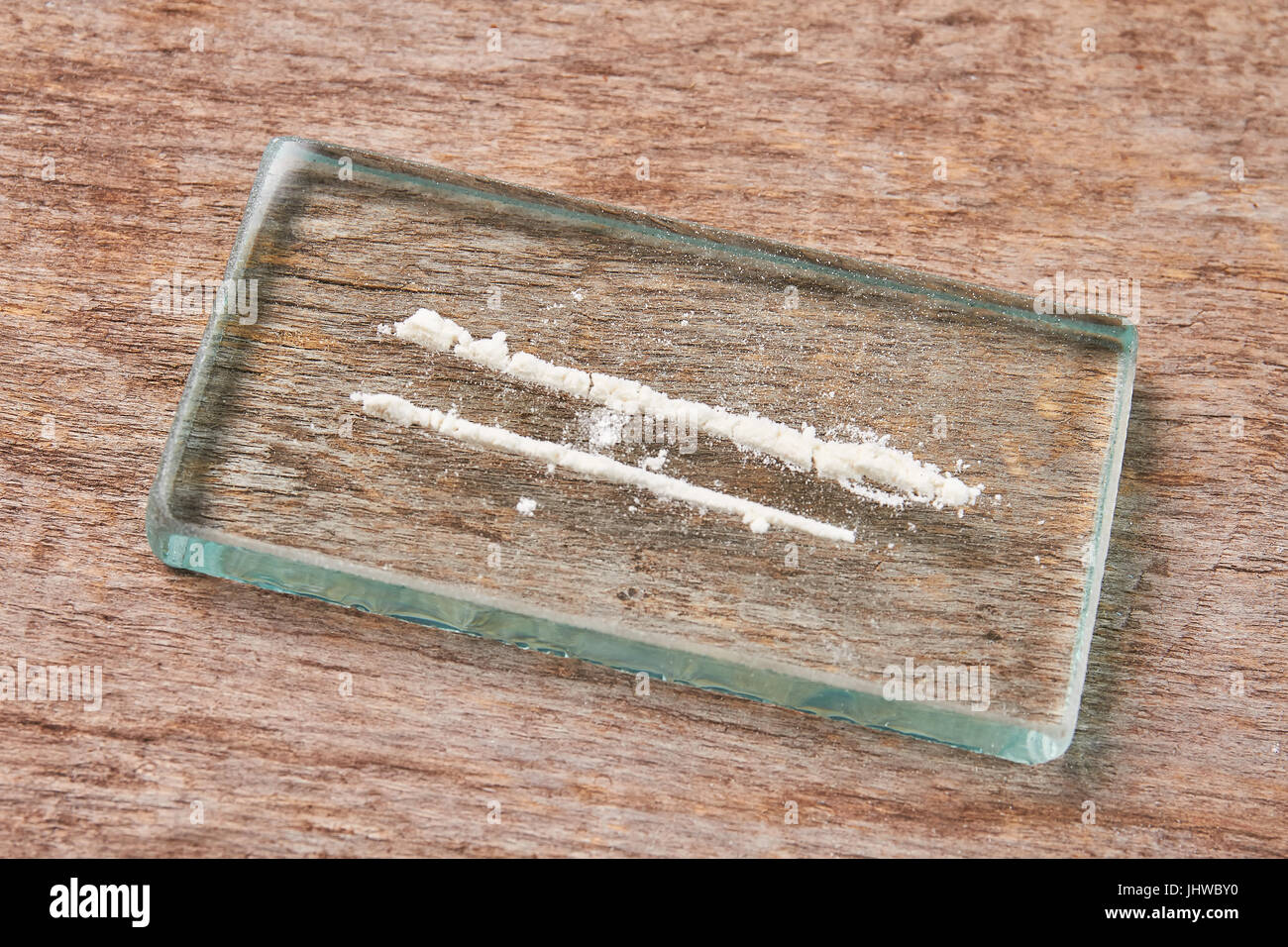 White powder, glass, wooden background Stock Photo - Alamy