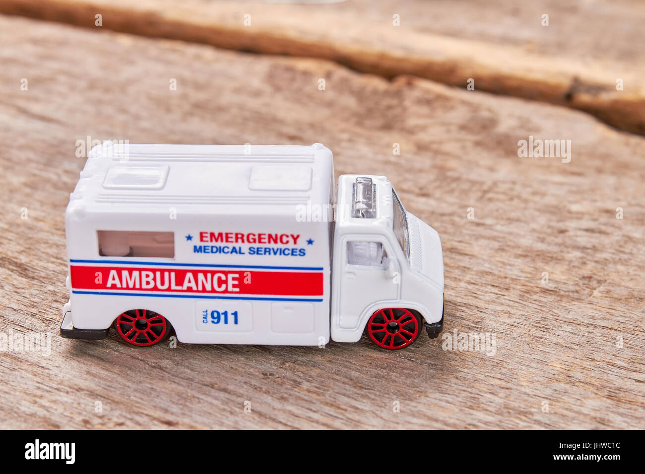 Emergency ambulance on wooden background Stock Photo - Alamy