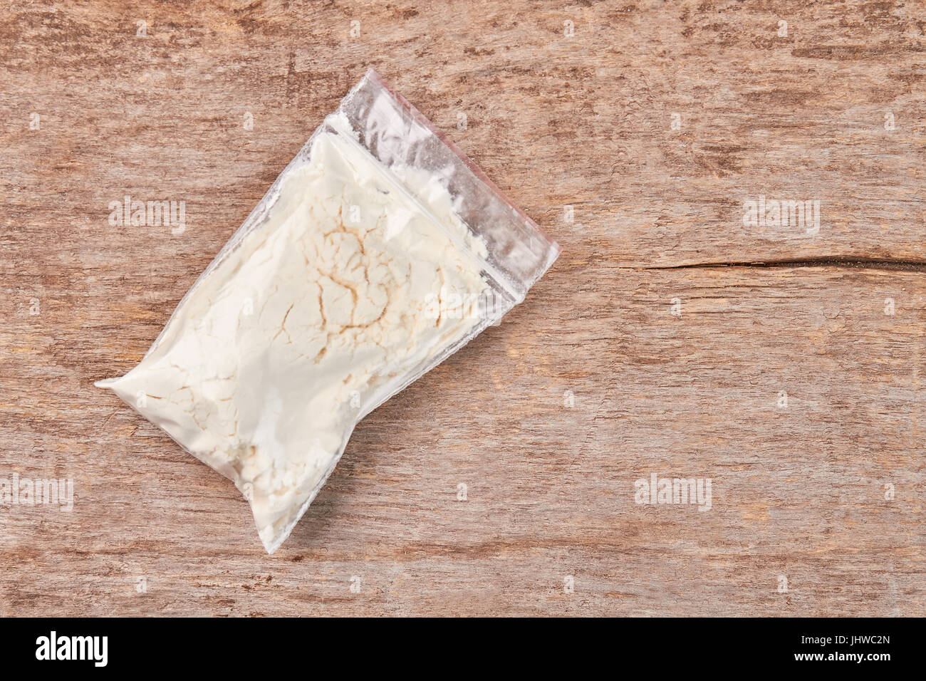 Packet with narcotics on wooden background Stock Photo - Alamy