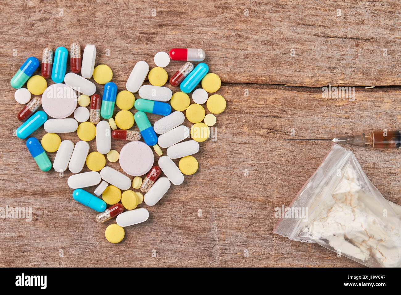 Pills shaped heart, narcotics Stock Photo - Alamy