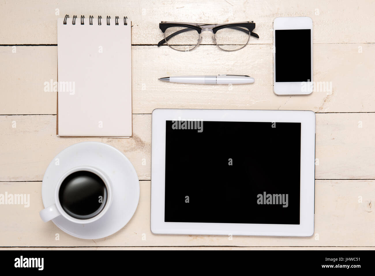 White set. Pen, eyeglasses, coffee and notebook on table. Top view ...