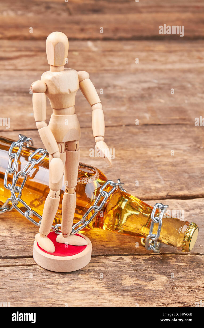 Alcohol bottle wrapped with metal chain Stock Photo - Alamy