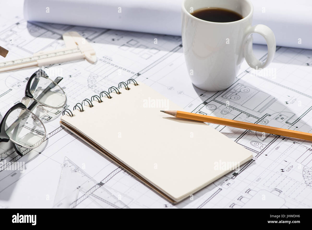 Construction projects. Planning. Open blueprints with a pencil and ...