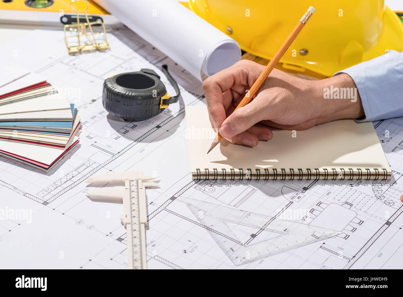 Working on blueprints. Construction project with hands writing on ...