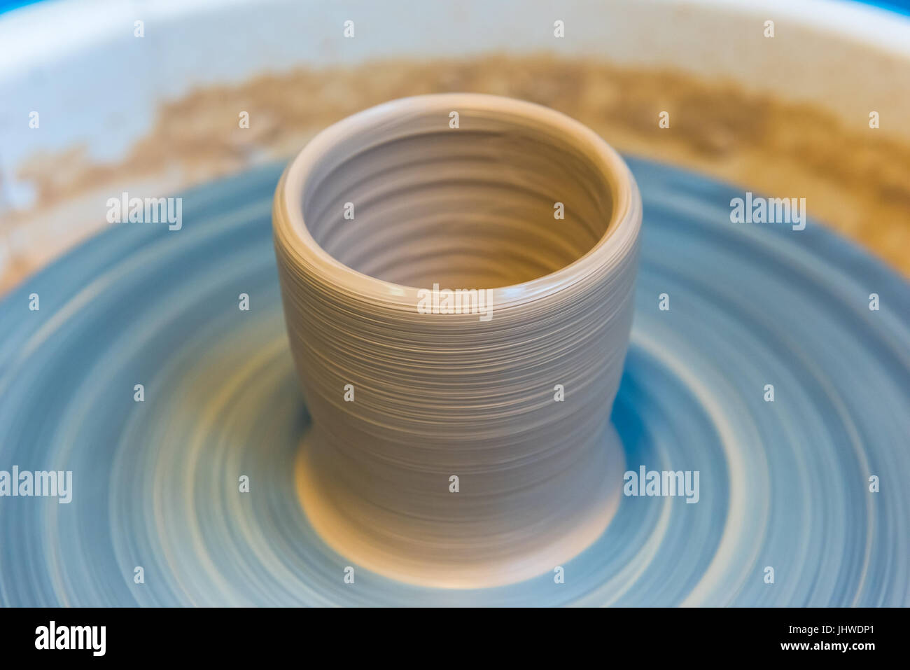 Pottering - creating a clay cup in process. Horizontal shot with a ...