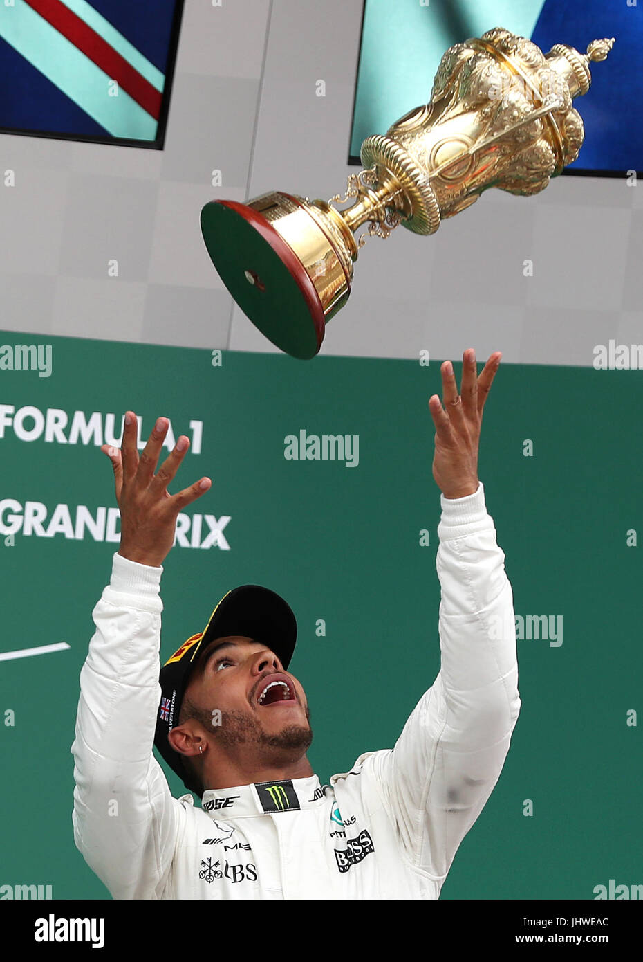 Mercedes' Lewis Hamilton celebrates victory on the podium after the ...