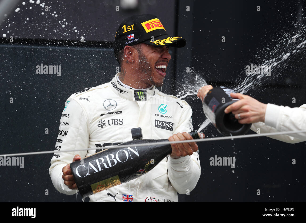 Mercedes' Lewis Hamilton celebrates victory on the podium after the ...