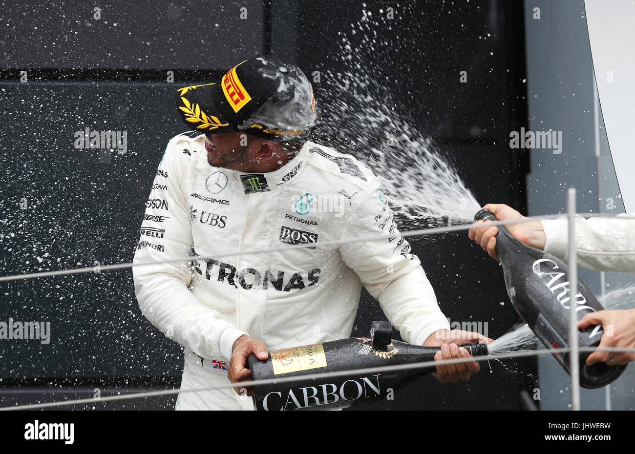 Mercedes' Lewis Hamilton celebrates victory on the podium after the ...