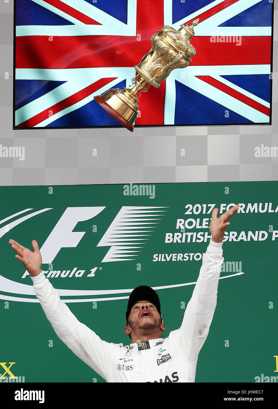 Mercedes' Lewis Hamilton celebrates his victory on the podium during ...