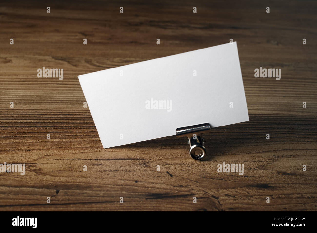 Photo of blank business card on wood table background. Mockup for ID ...