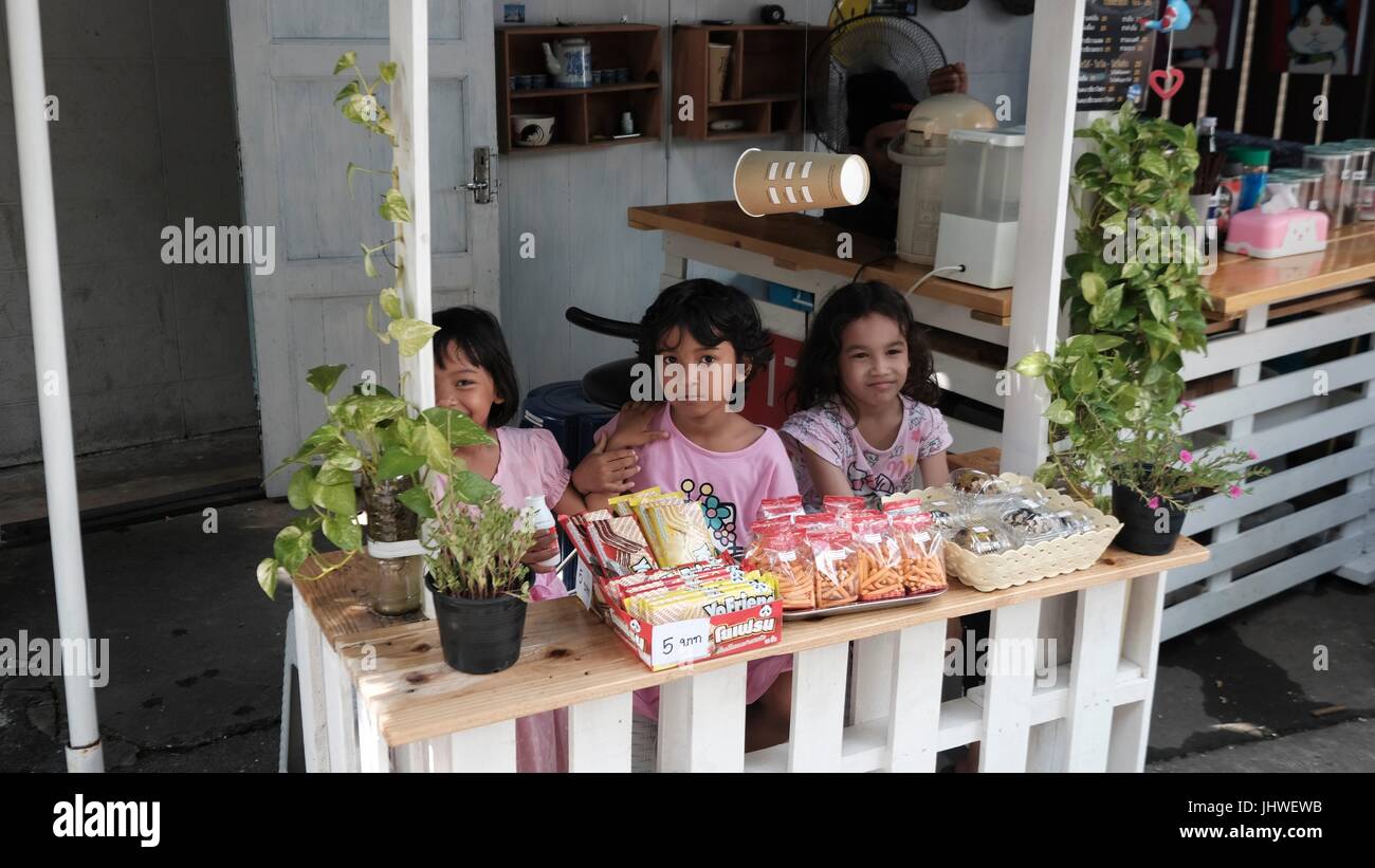 Three children stand hi-res stock photography and images - Alamy