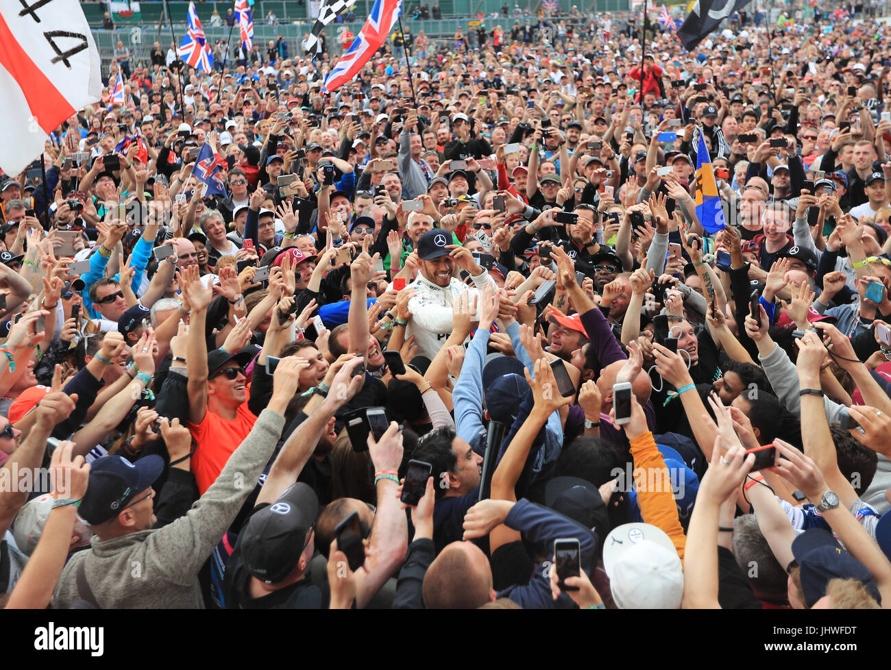 Mercedes' Lewis Hamilton celebrates his victory with the crowd during ...