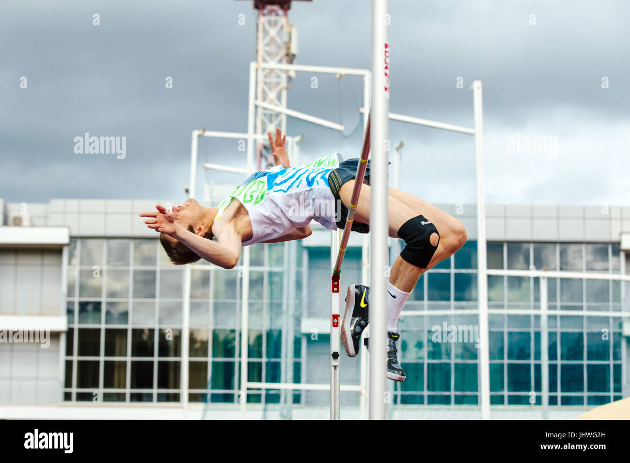 high jump male athlete successful attempt during Ural Championship in ...