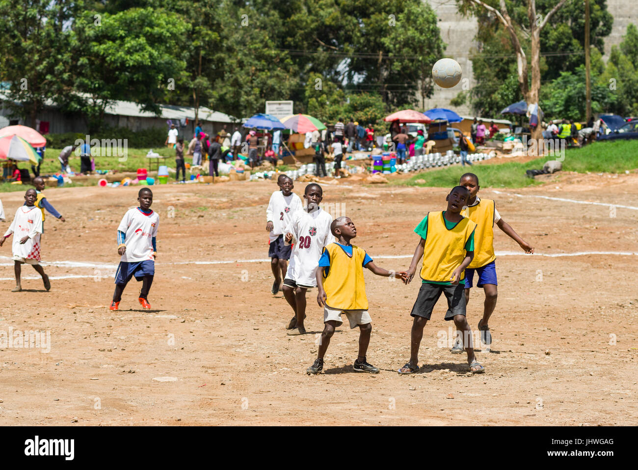 Children From Kibera Slum Playing Football On A Dusty Pitch, Nairobi ...