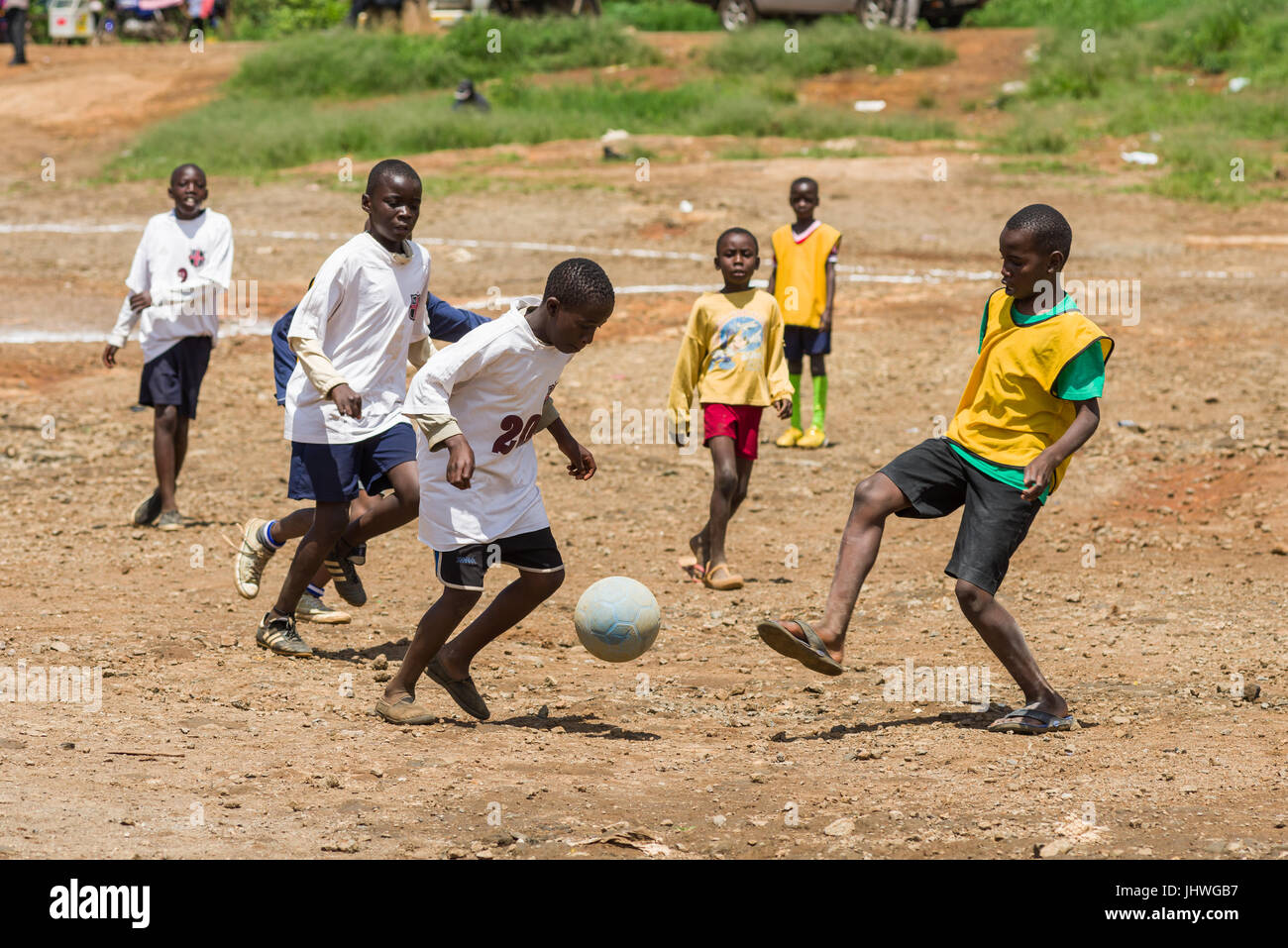 Children From Kibera Slum Playing Football On A Dusty Pitch, Nairobi ...