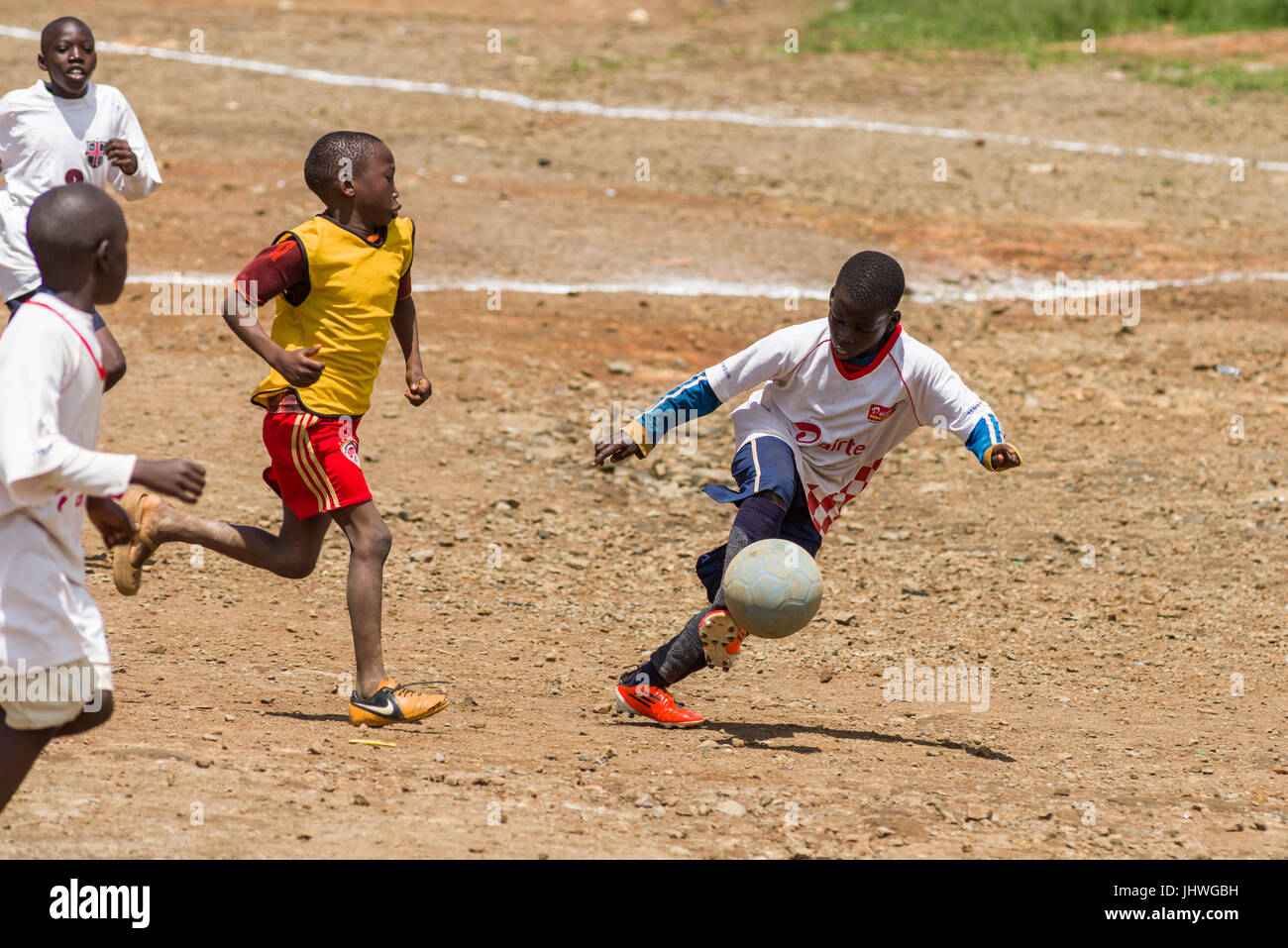 Children From Kibera Slum Playing Football On A Dusty Pitch, Nairobi ...