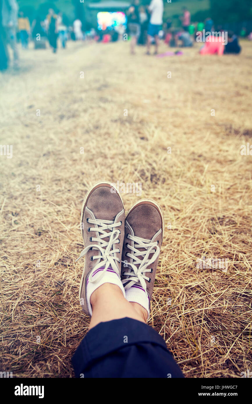 Teens at concert at summer festival. Legs of teenager at summer music ...