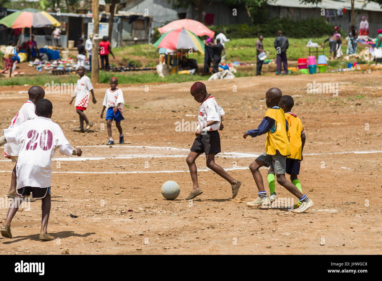 Children From Kibera Slum Playing Football On A Dusty Pitch, Nairobi ...