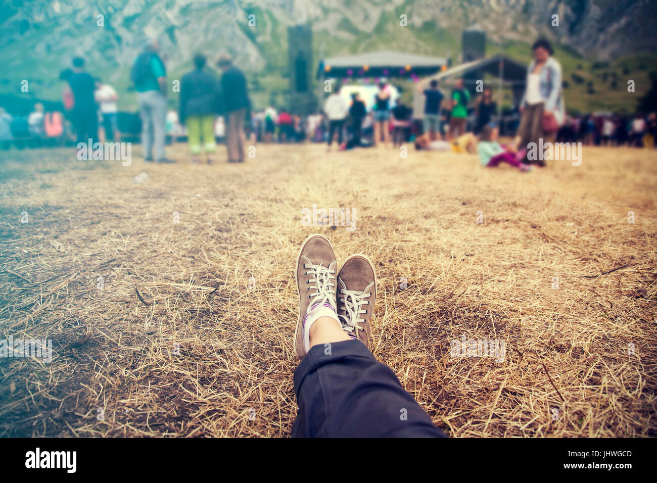 Teens at concert at summer festival. Legs of teenager at summer music ...