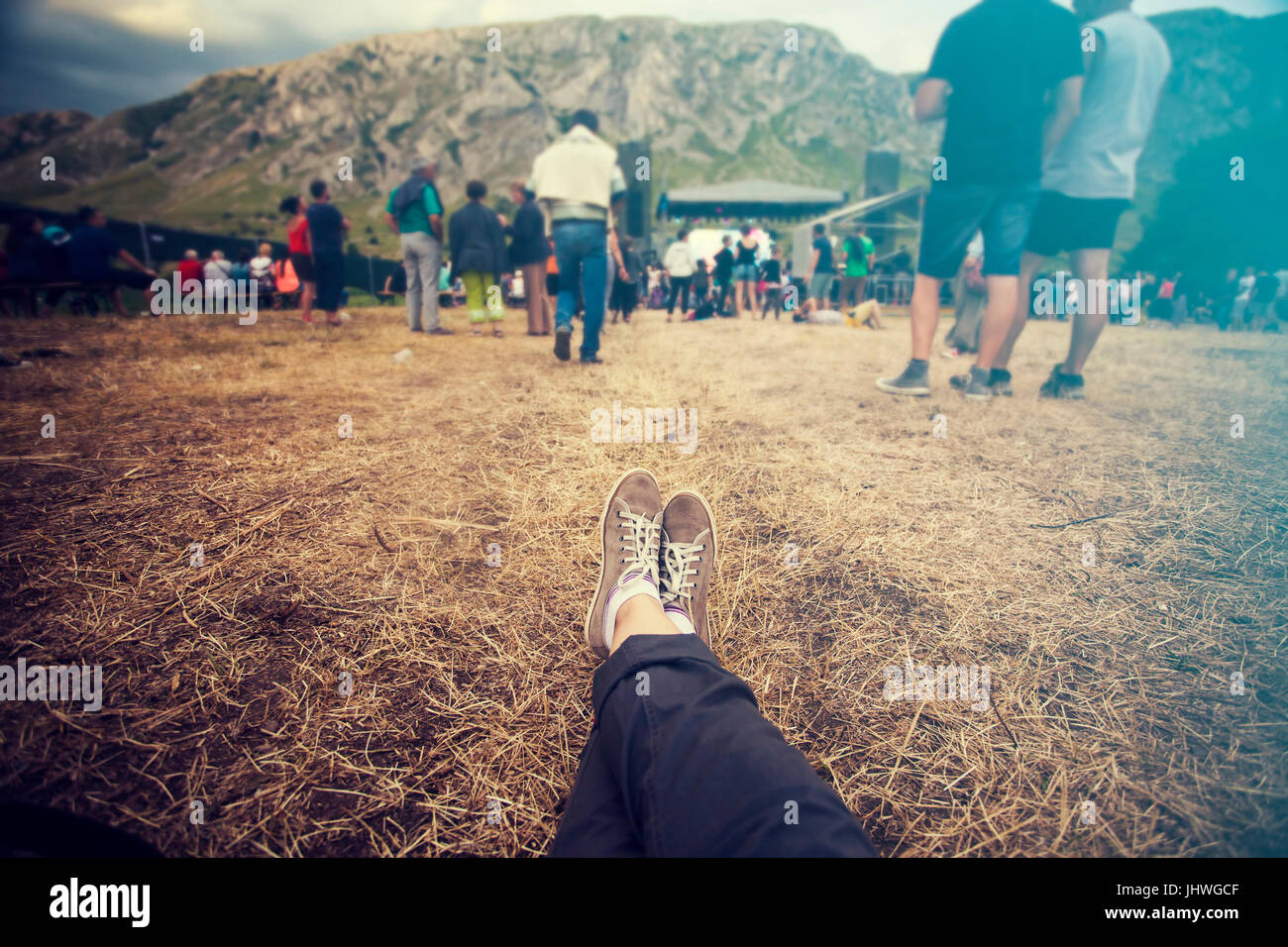 Teens at concert at summer festival. Legs of teenager at summer music ...