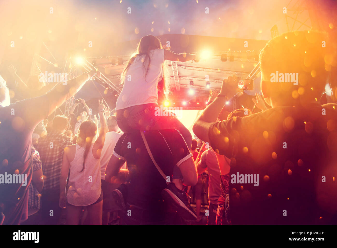 Photo of many people enjoying rock concert, audience applauding to ...
