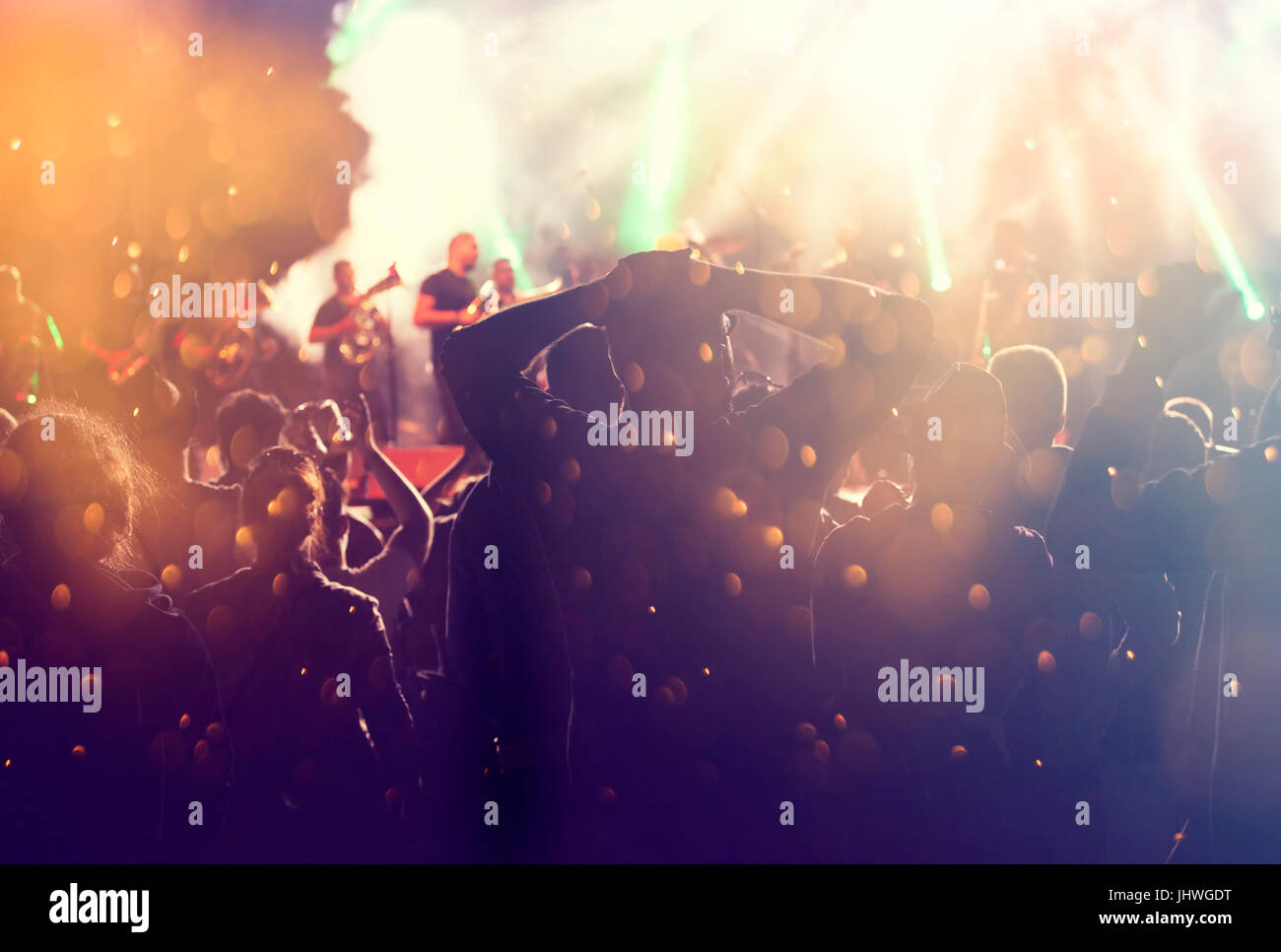 Photo of many people enjoying rock concert, audience applauding to ...