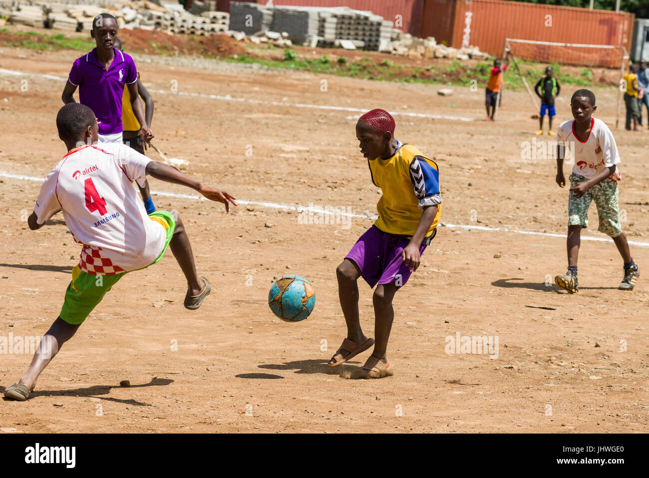 Children From Kibera Slum Playing Football On A Dusty Pitch, Nairobi ...