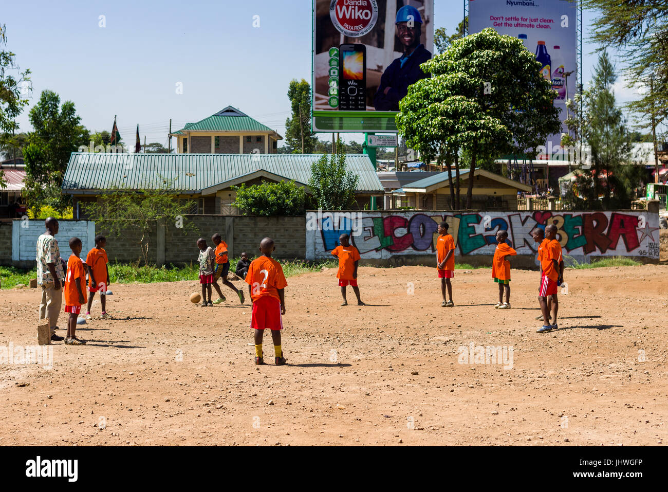 Children From Kibera Slum Playing Football On A Dusty Pitch, Nairobi ...