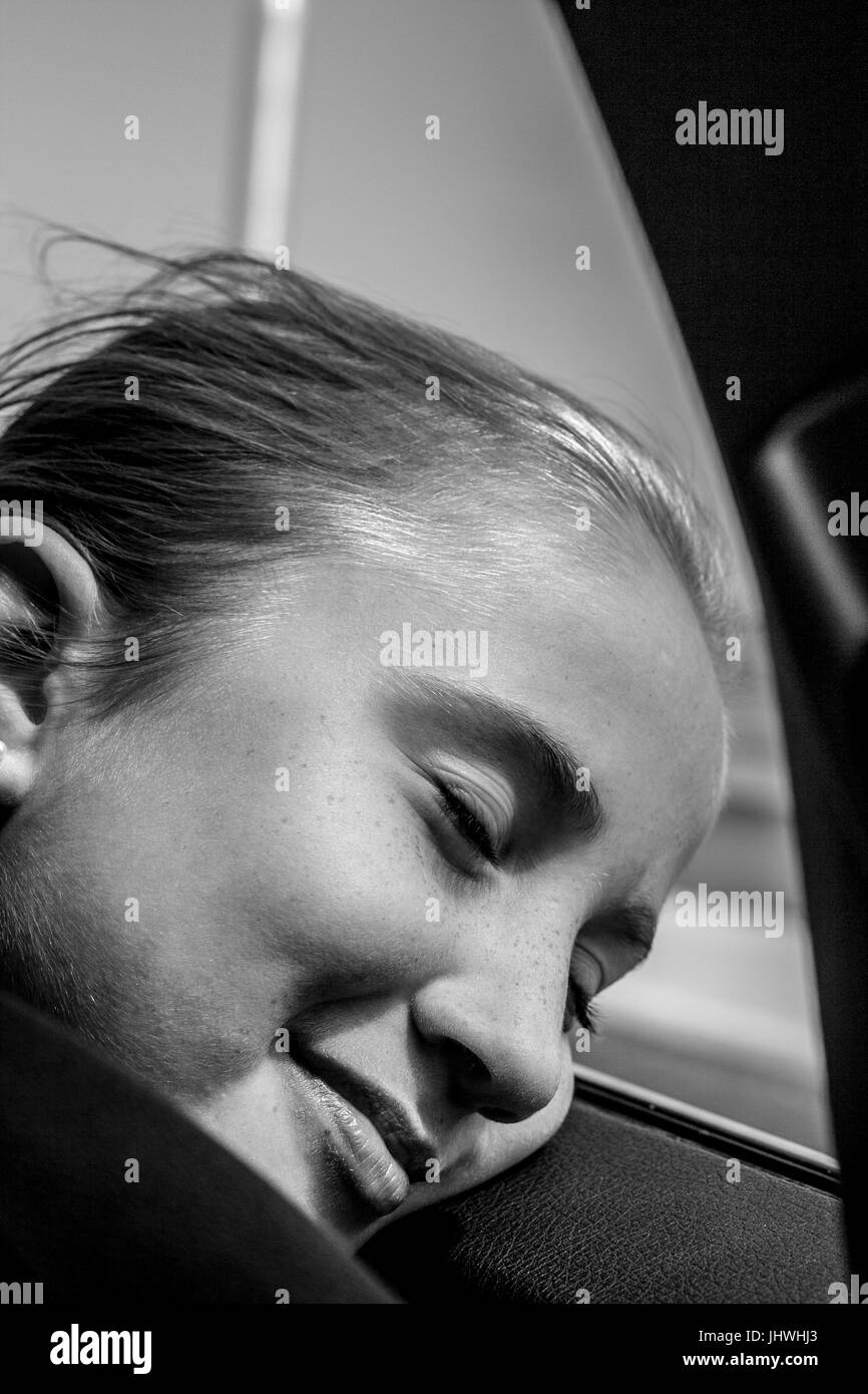 Child enjoying the wind in her hair, head out the window of a moving ...