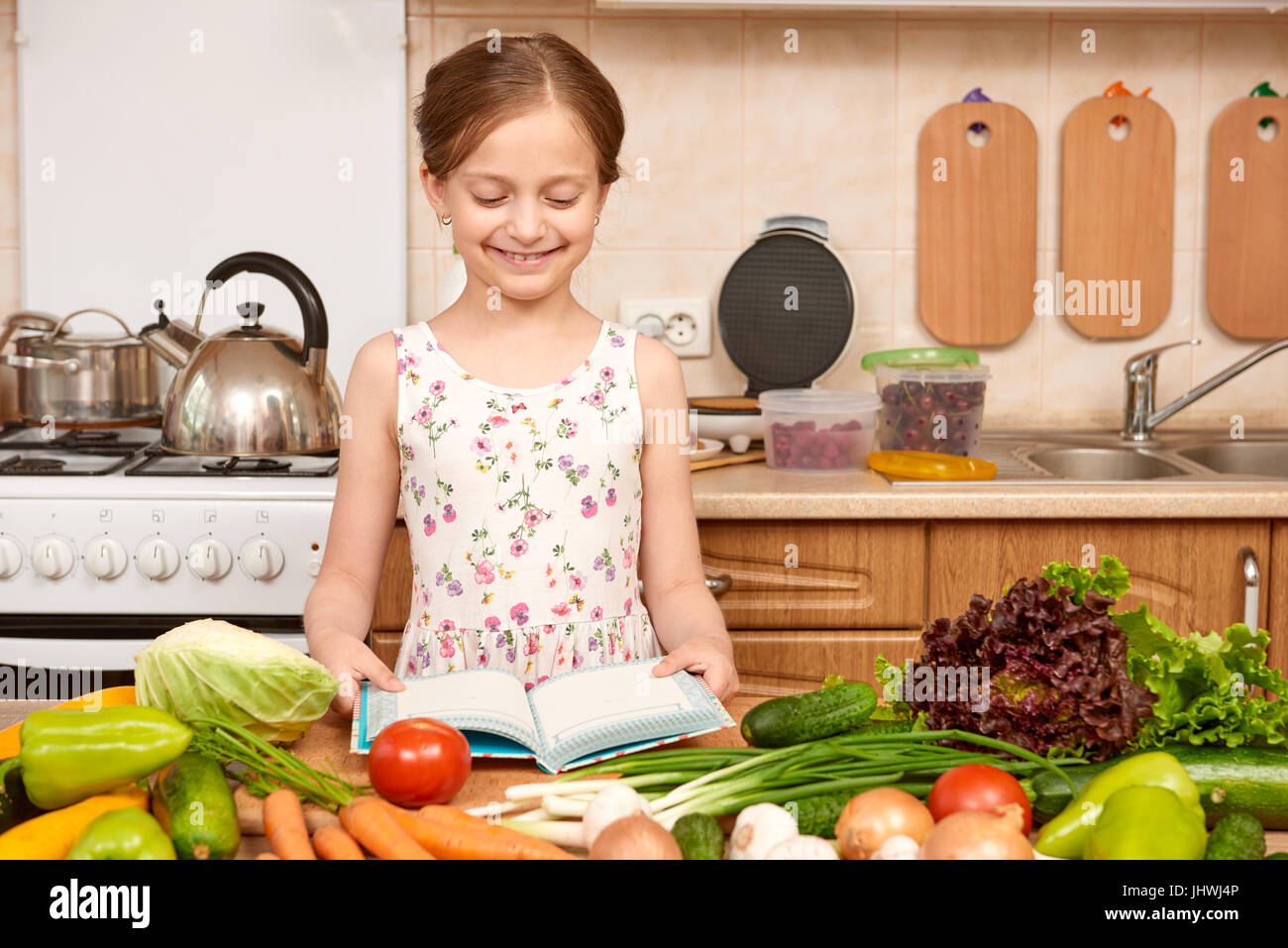 girl cooking, kitchen interior with fresh fruits and vegetables on the ...
