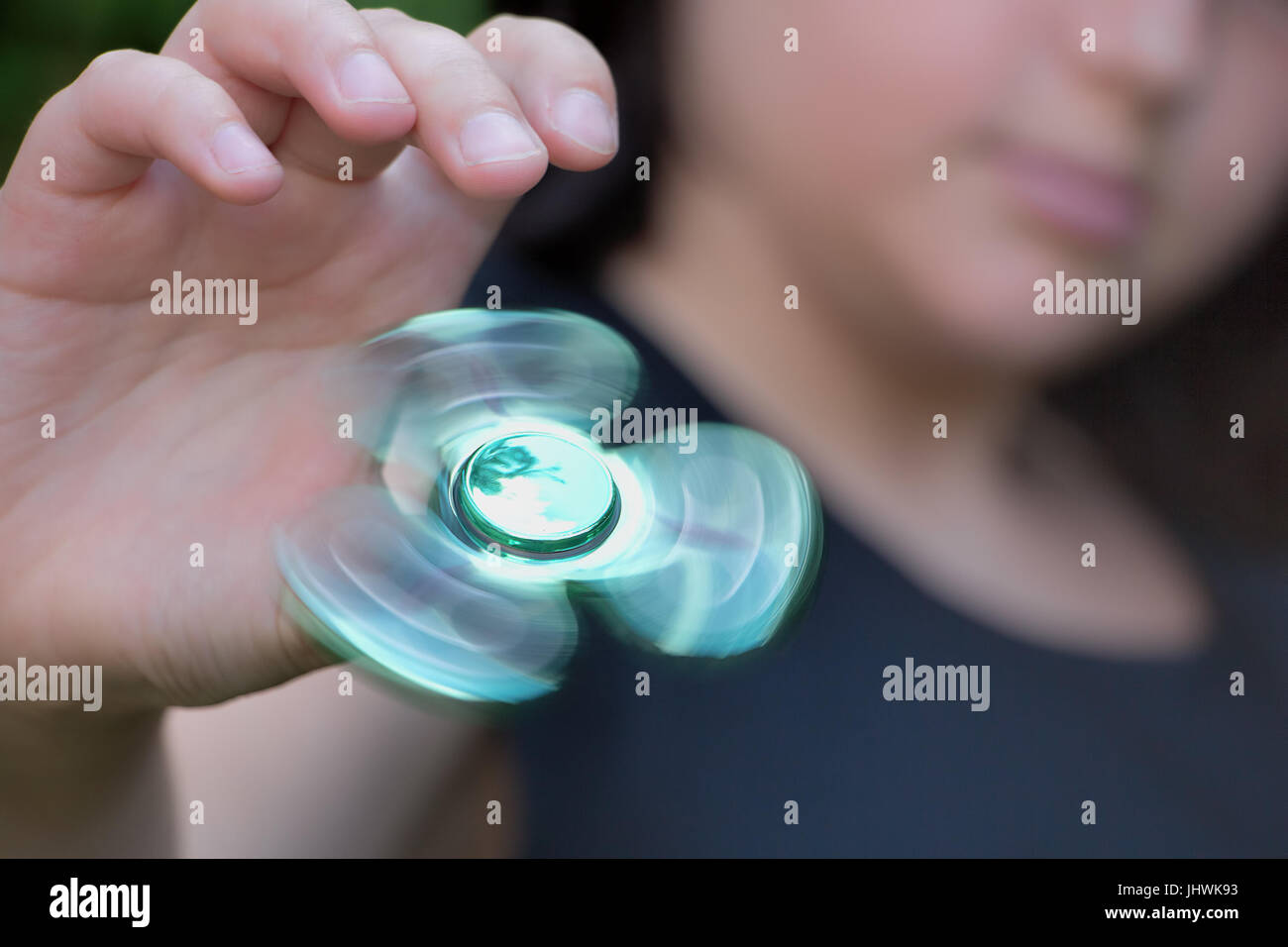 Playing with fidget spinner Stock Photo - Alamy
