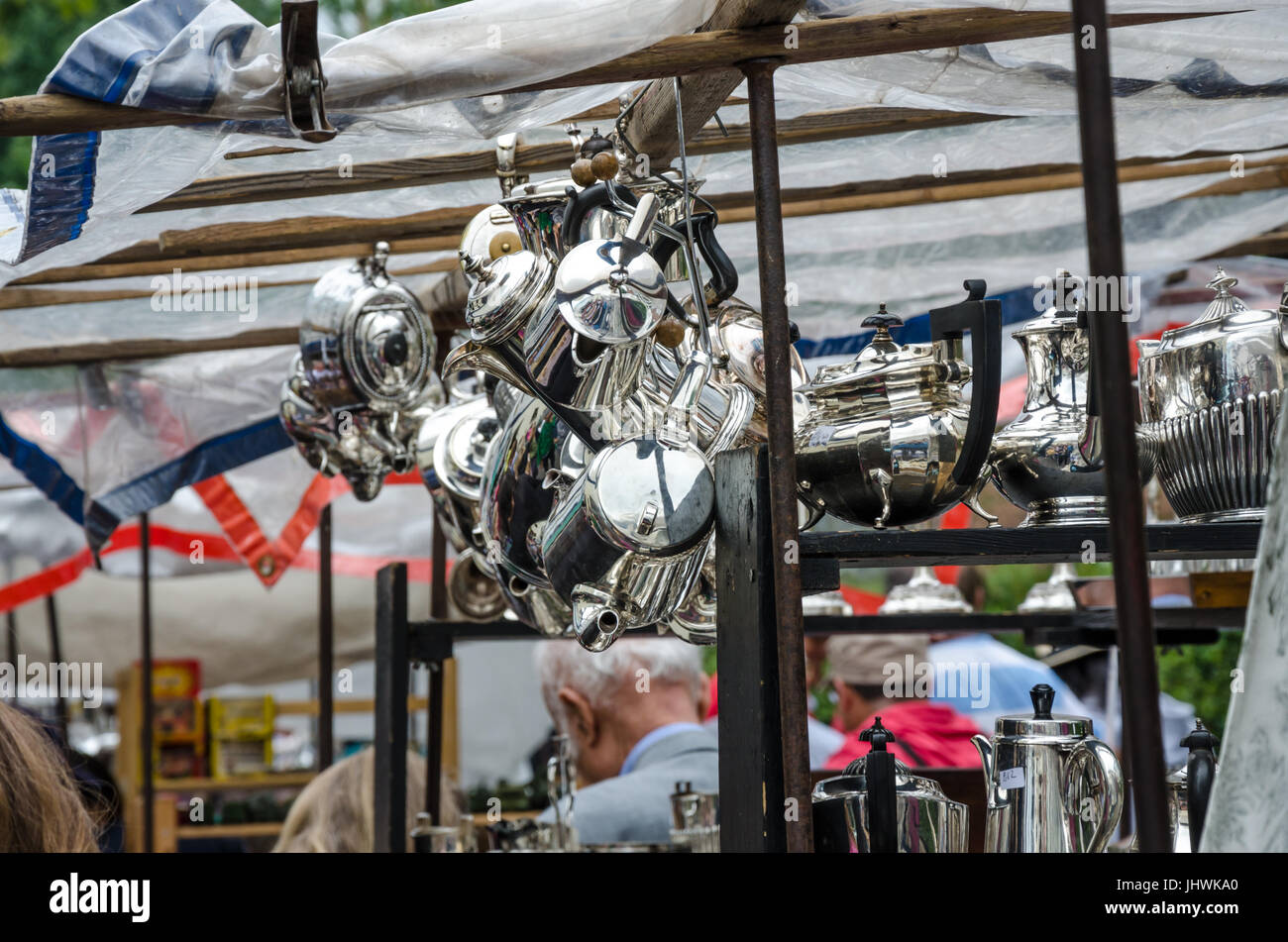 Shiny teapots hang from the roof of a stall in Portobello market Stock ...