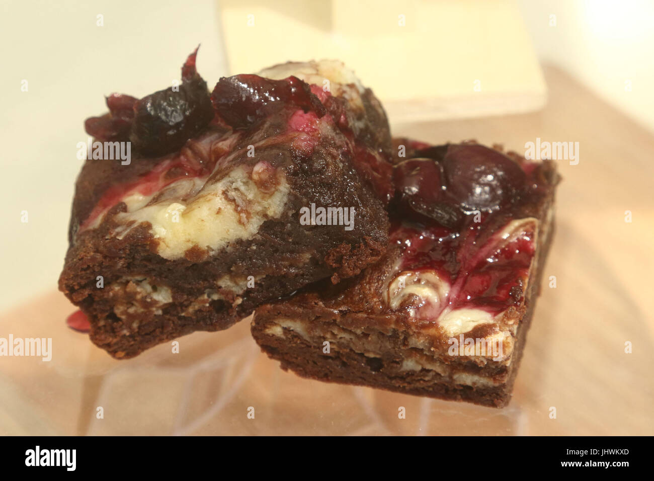Chewy chocolate brownies with cherries and cheesecake filling Stock ...