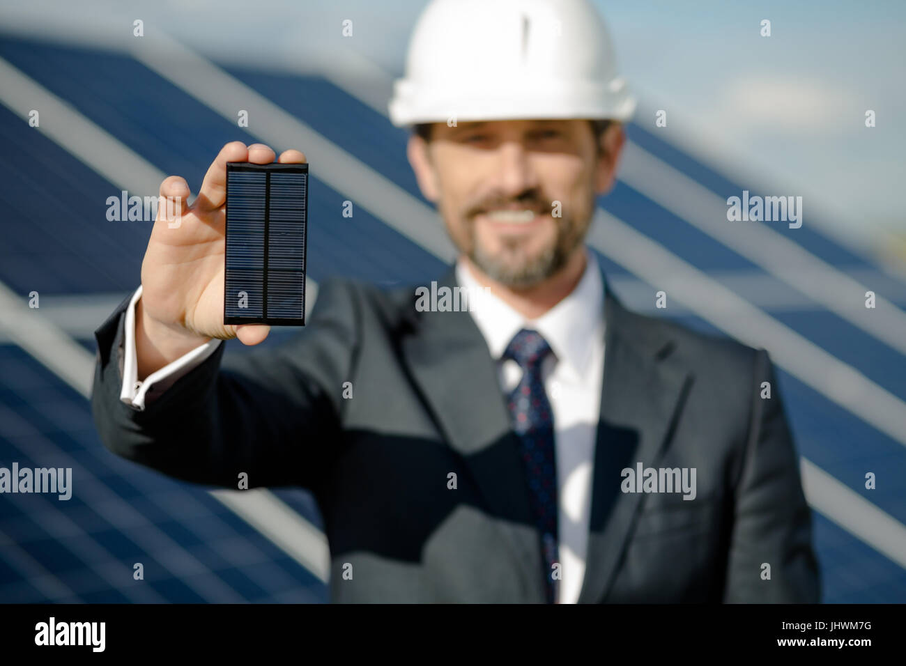 Man in business suit holding photovoltaic detail of solar panel Stock ...