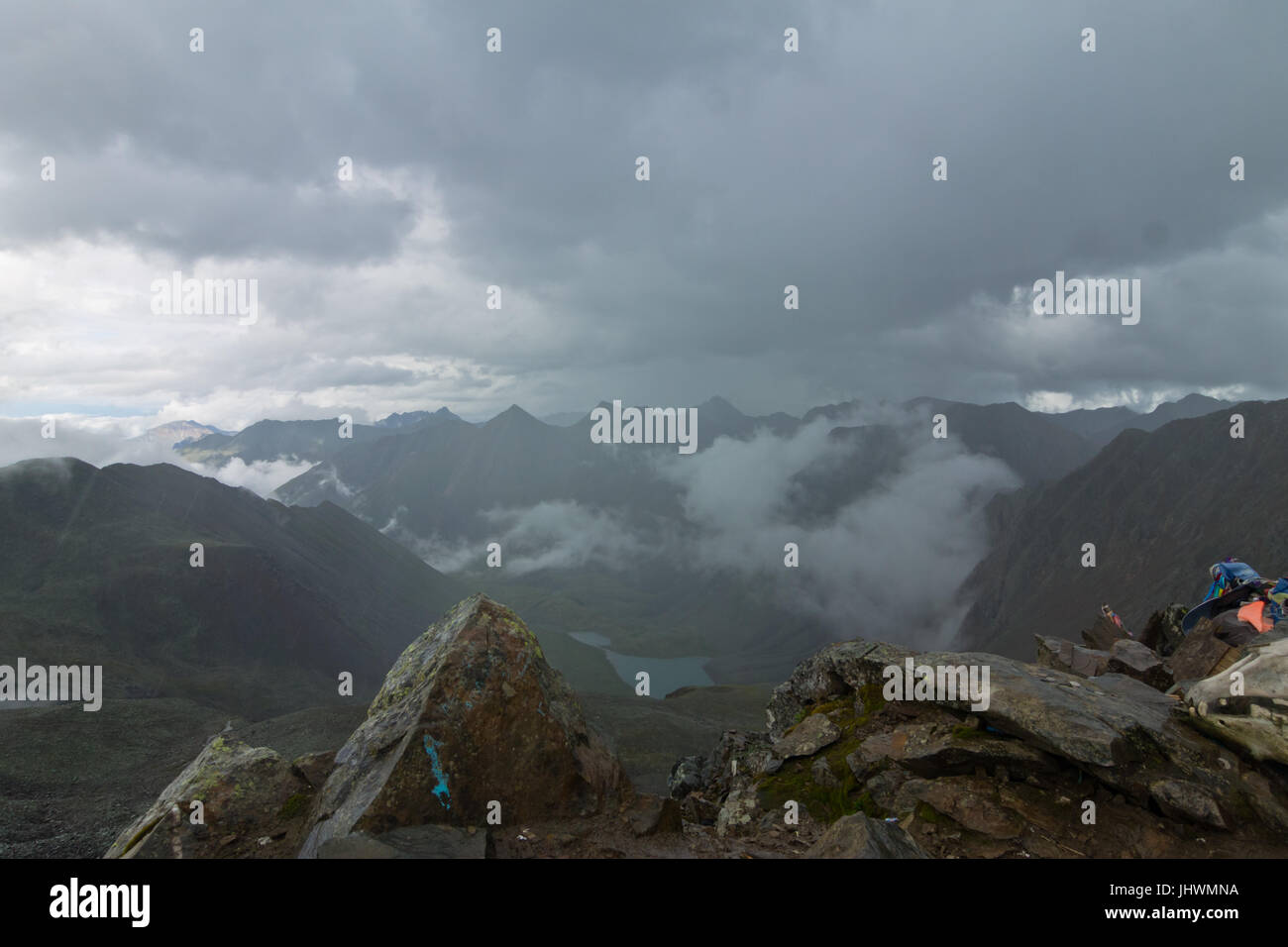 Peaks of rocky mountains in clouds and fog Stock Photo - Alamy