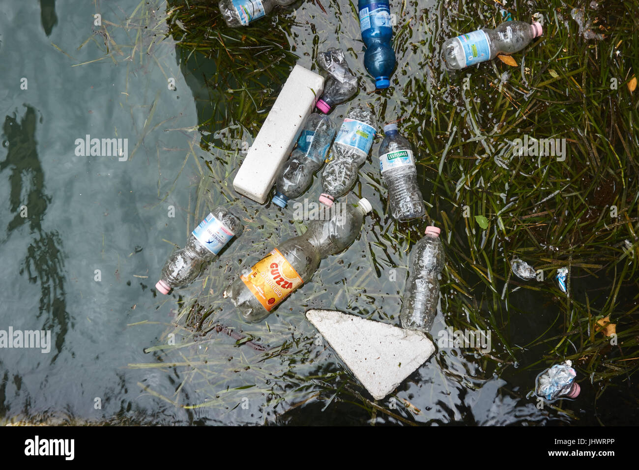 Plastic bottles floating in water. Venice. Italy Stock Photo - Alamy