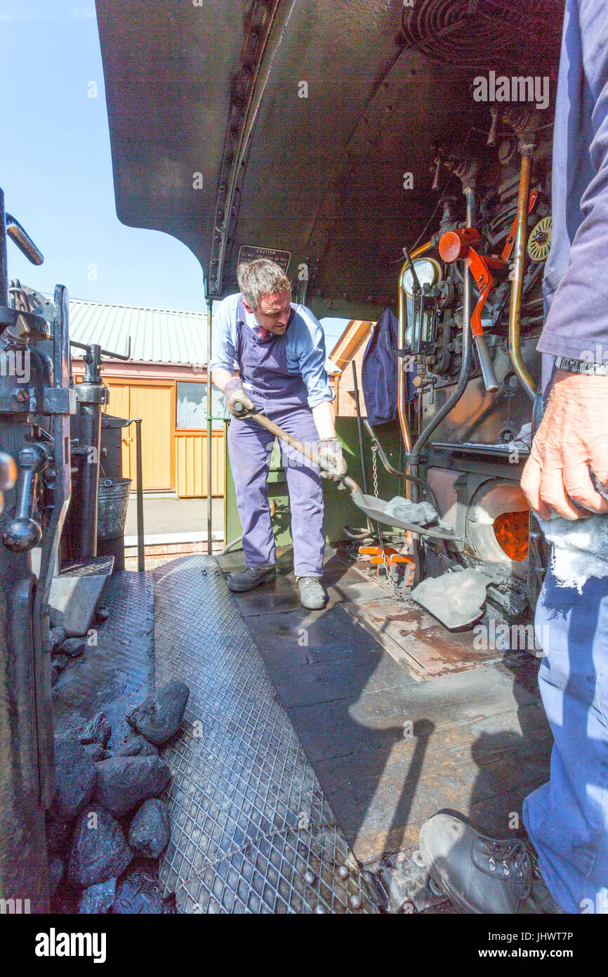 The fireman of ex-GWR loco 6960 'Raveningham Hall' adds some more coal ...