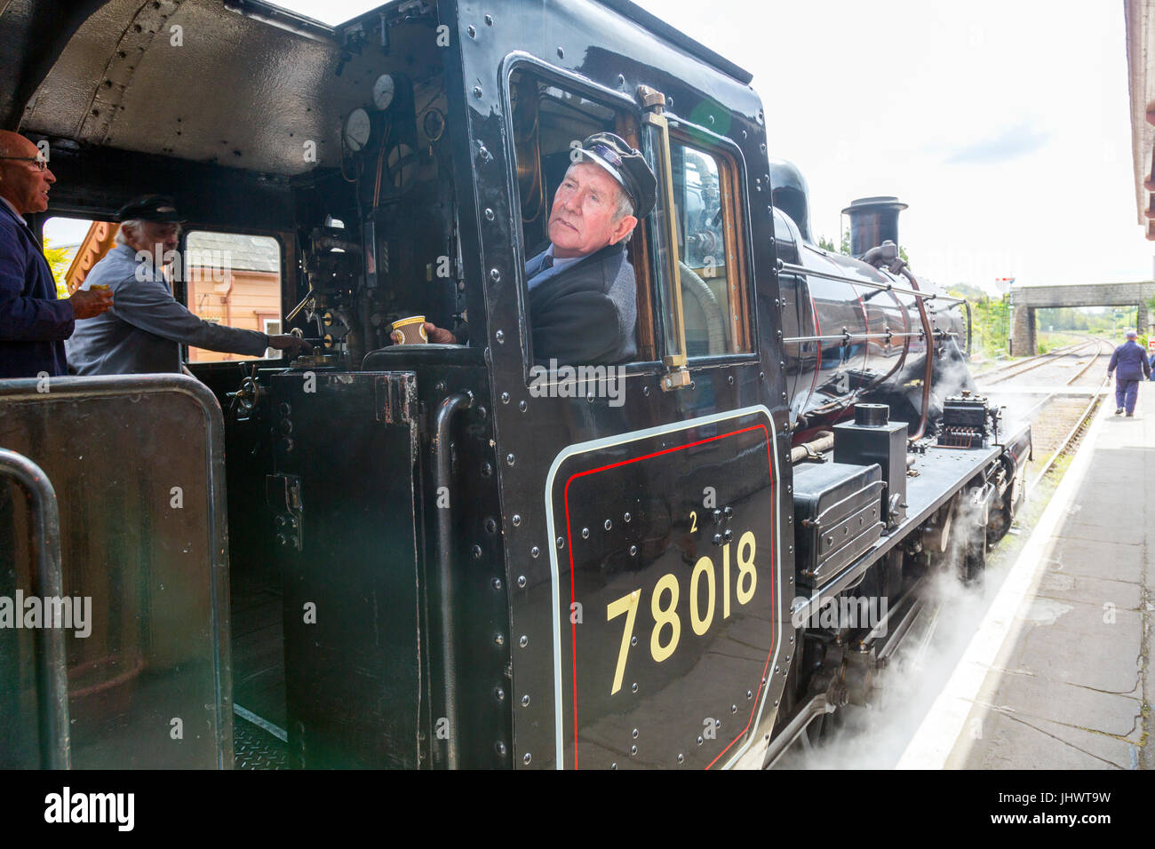 The crew of Ex-BR loco 78018 wait for the 'right away' at Williton ...