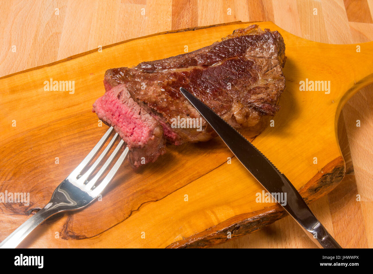 Maminha de alcatra steak cooked to rare or medium on cutting wooden ...
