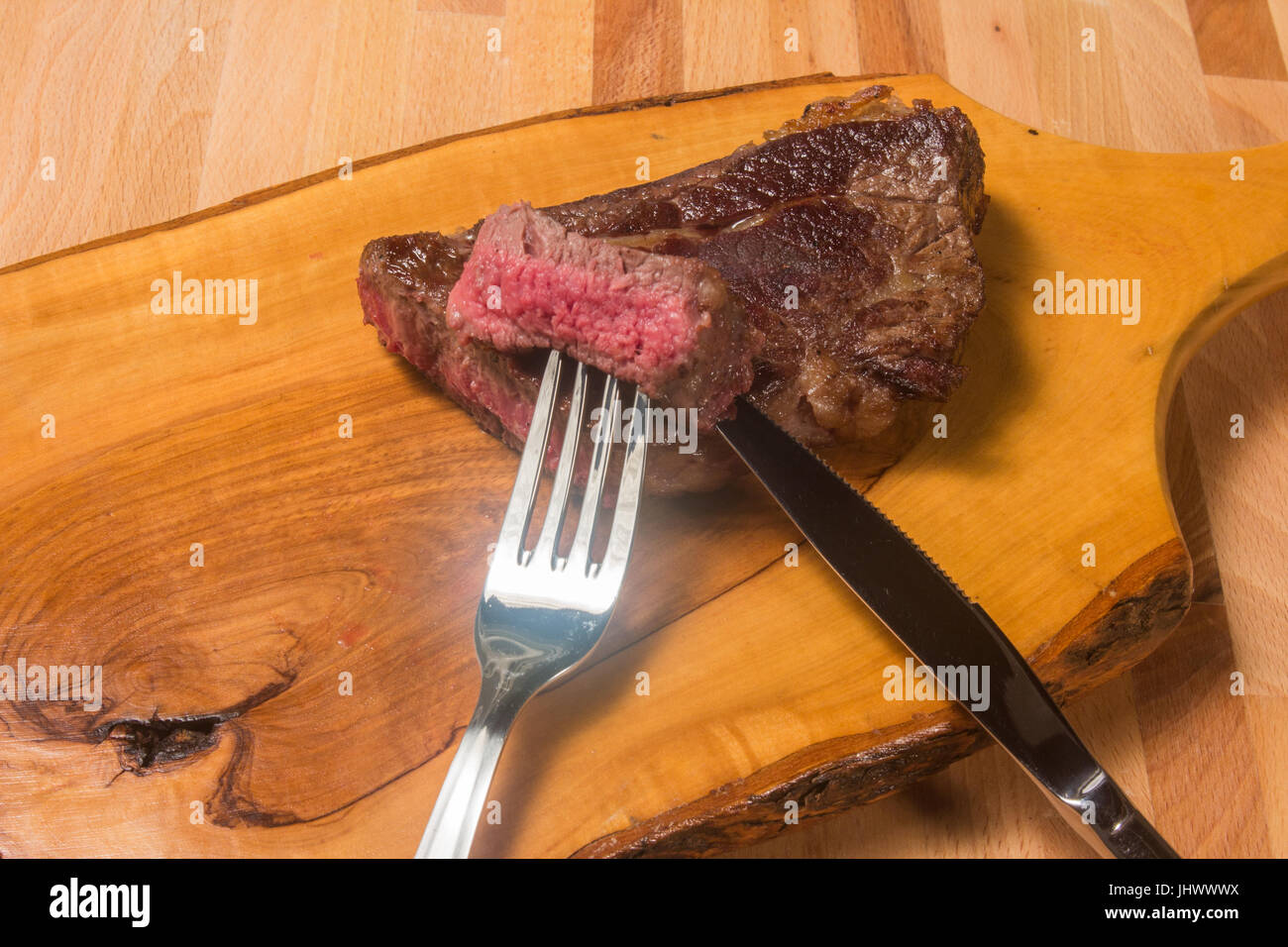 Maminha de alcatra steak cooked to medium rare on wooden background ...