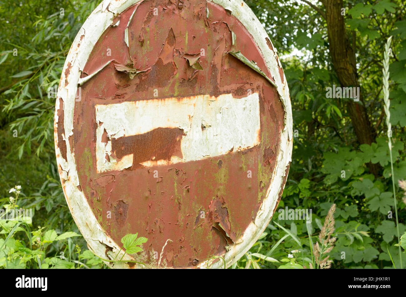 An old rusty road sign is prohibited in the forest Stock Photo - Alamy