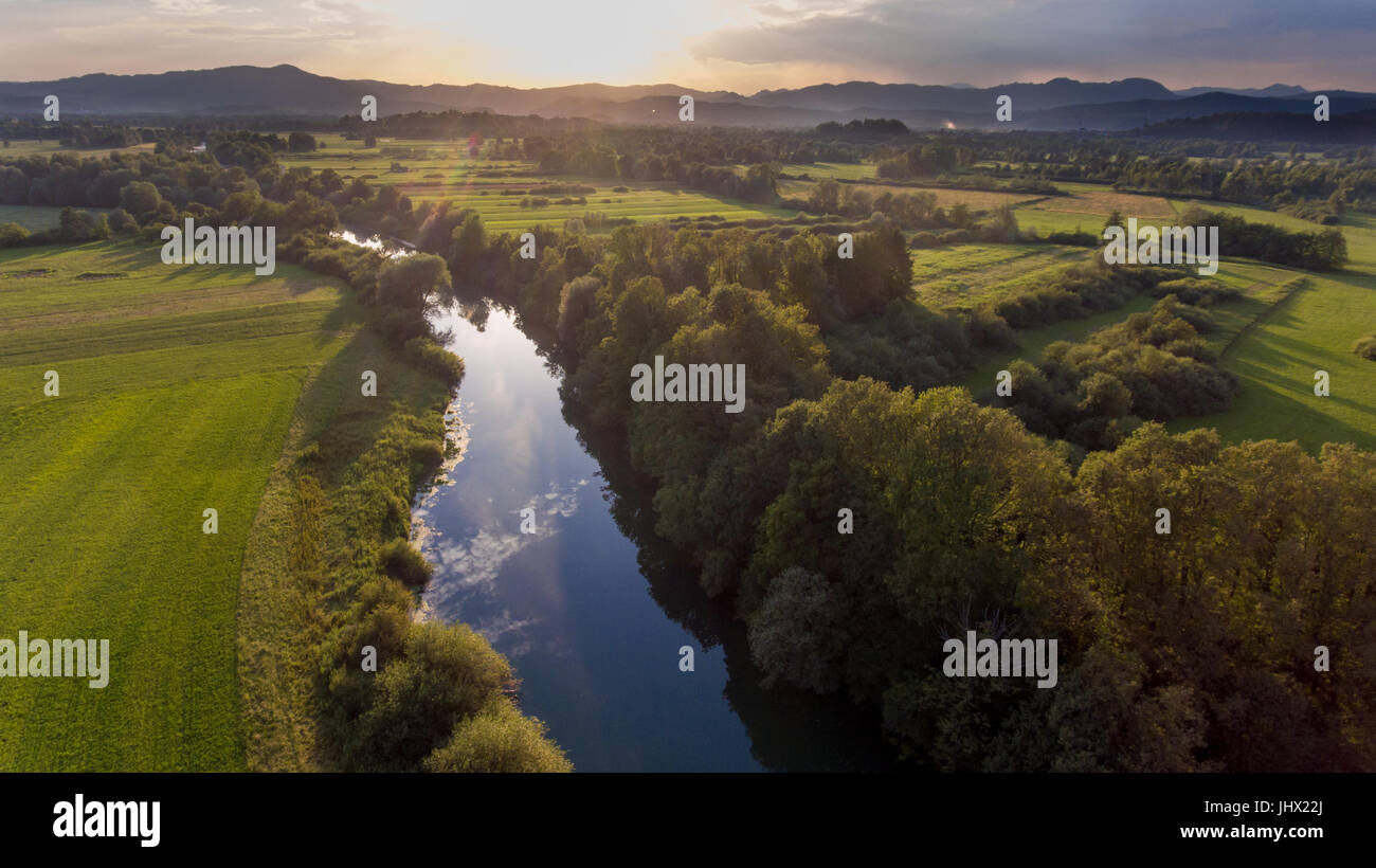 Aerial view of river bending across fields at sunset Stock Photo - Alamy